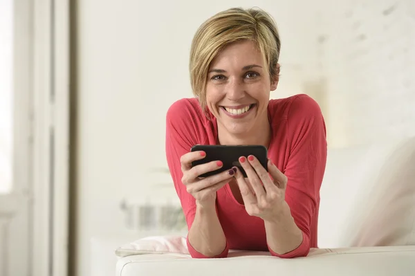 Young beautiful Caucasian woman happy using internet app on mobile ...