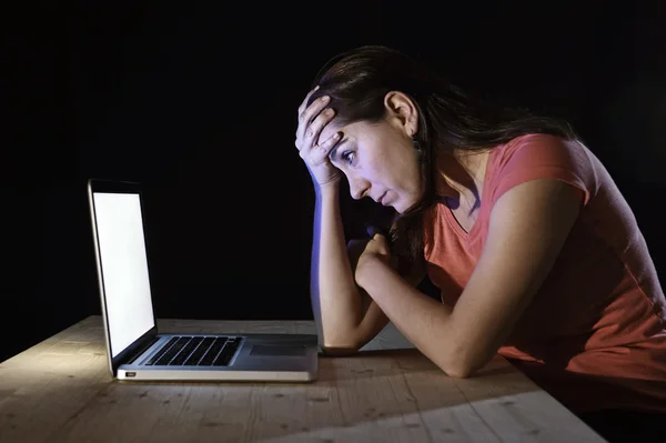 Depressed worker or student woman working with computer alone late ...