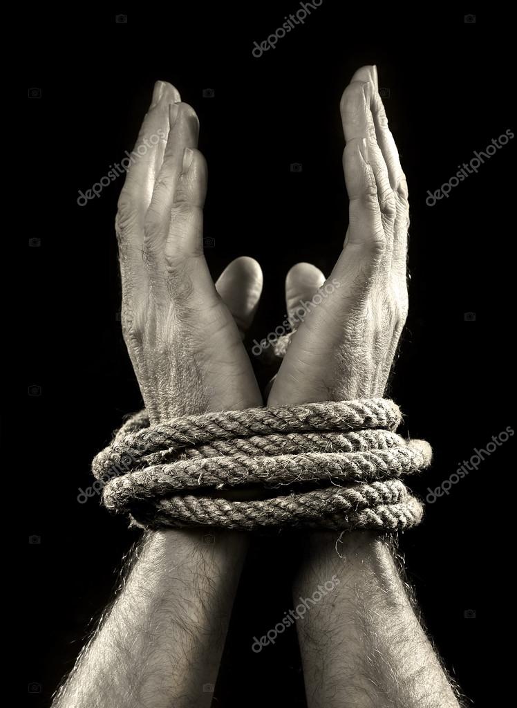 White man hands wrapped with rope around wrists in victim abused in ...
