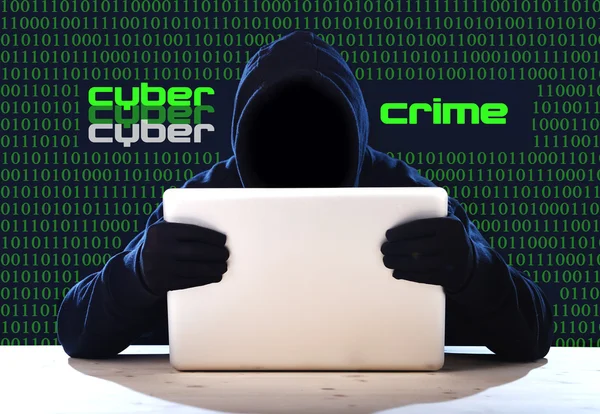 Hacker man in black using computer laptop for criminal activity hacking ...
