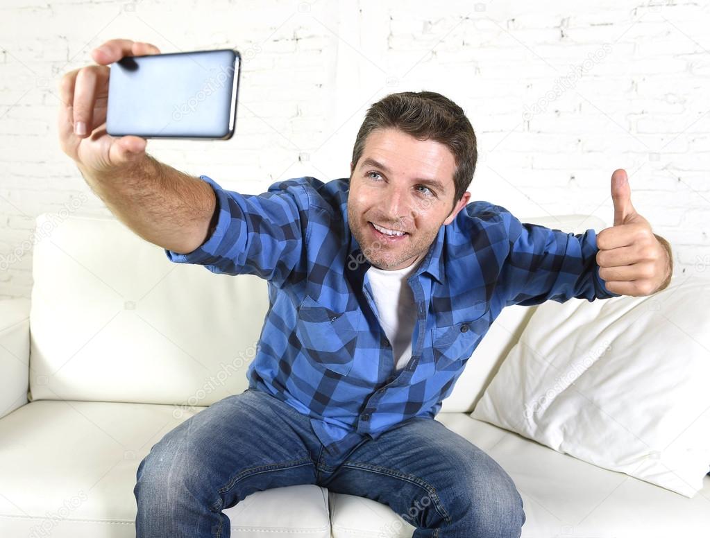 Young attractive 30s man taking selfie picture or self video with ...