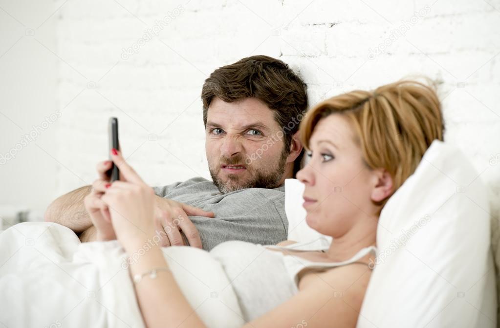 Couple In Bed Husband Frustrated Upset Unsatisfied While Wife Using