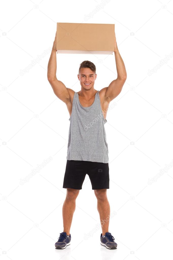 Man Holding Box Above His Head — Stock Photo © studioloco #79840630