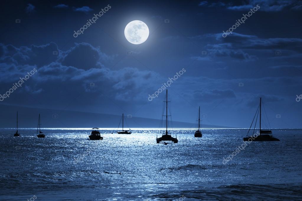 This dramatic photo illustration of a nighttime sky over a calm ocean ...