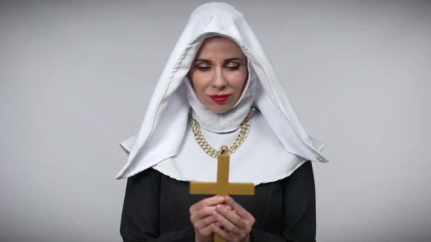 Disappointed Caucasian nun throwing away cross and leaving. Portrait of ...