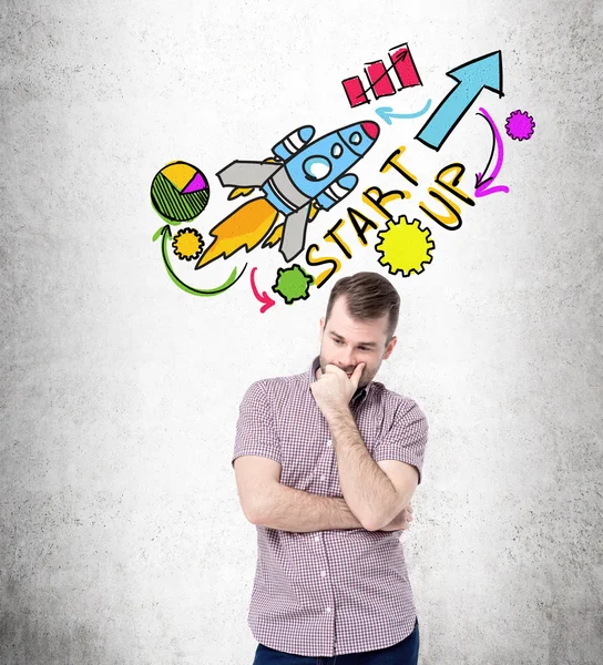 Businessman with hand on chin thinking, startup pictures over his head ...