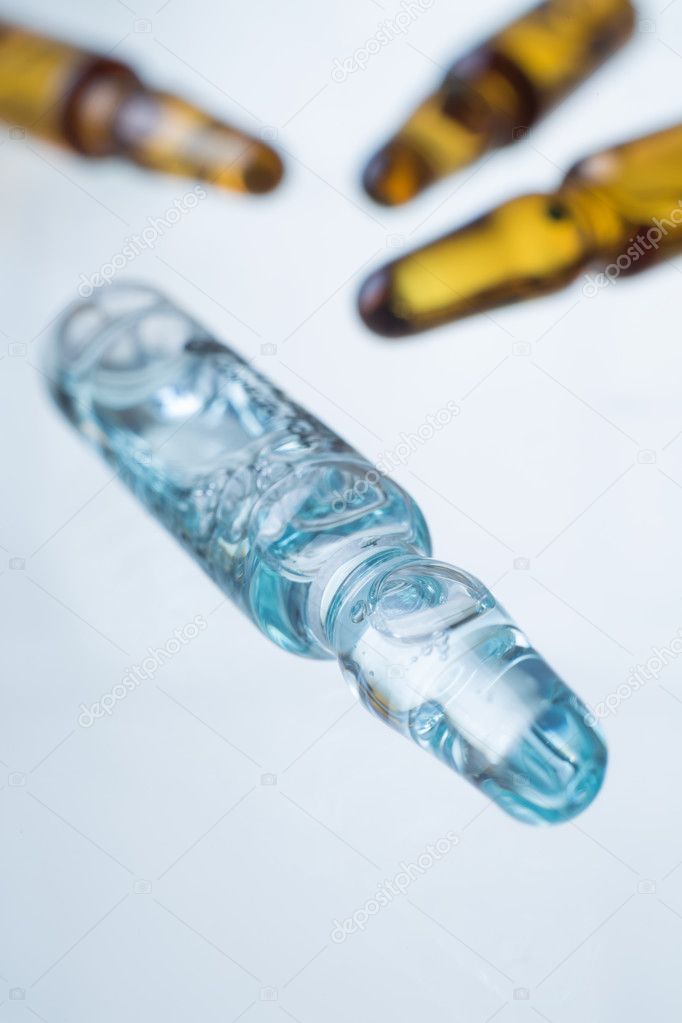 White ampoulel, other ampoules at background, close up. Concept of ...