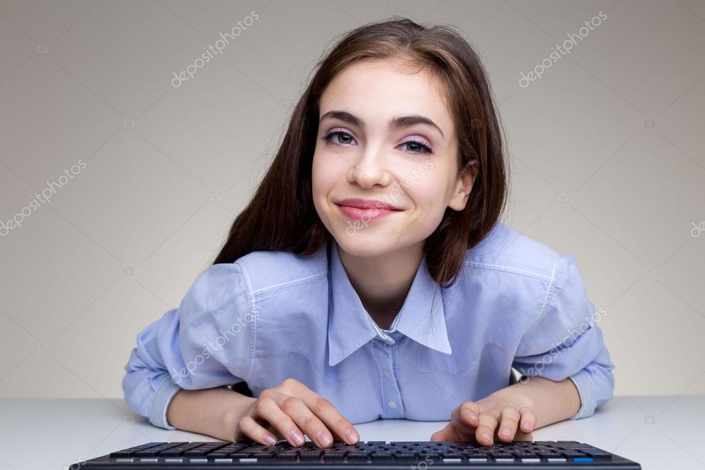 Pretty smiling girl using keyboard Stock Photo by ©denisismagilov 114546496