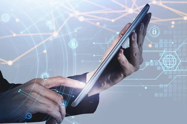 Businessman holding portable device in hands, double exposure with ...