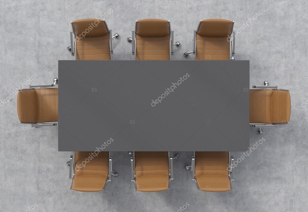 Top view of a conference room. A dark grey rectangular table and eight ...