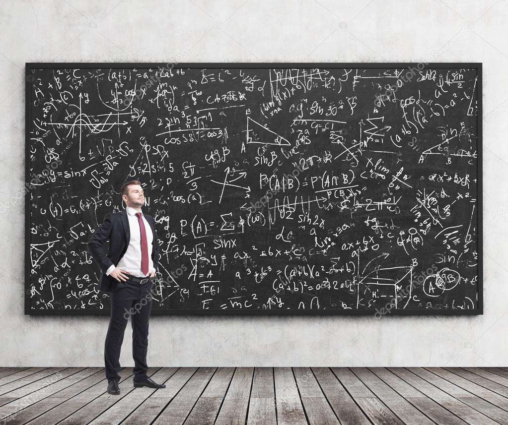 Side view of a confident young man who stands in front of black ...