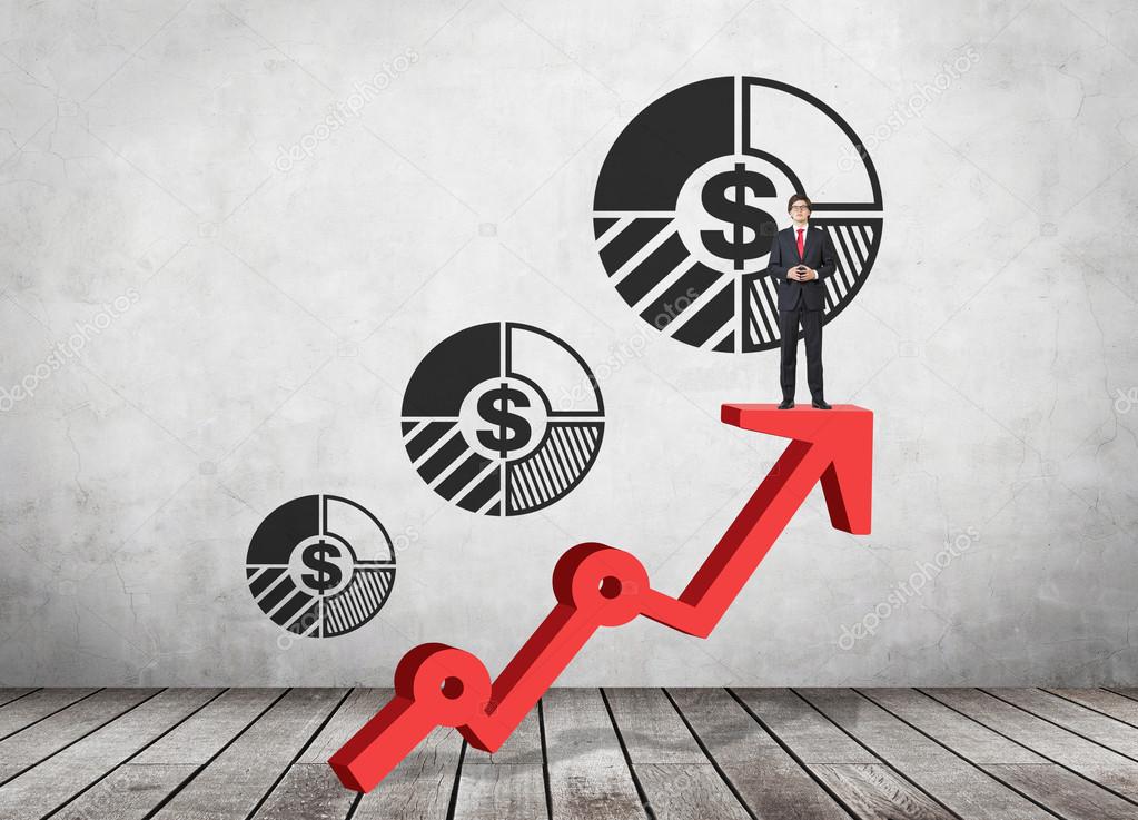 A young man standing and thinking on a thick red growing graph looking ...