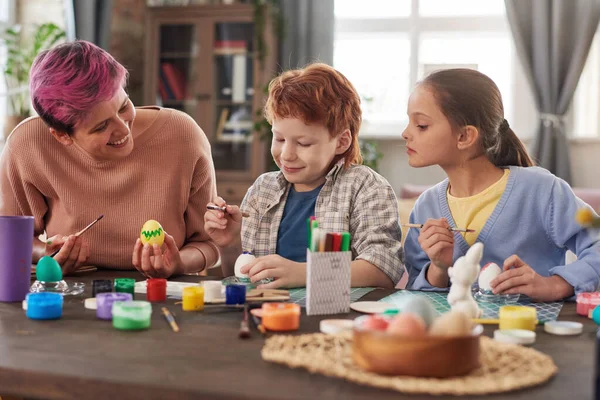 Family decorating Easter eggs - Stock Image - Everypixel