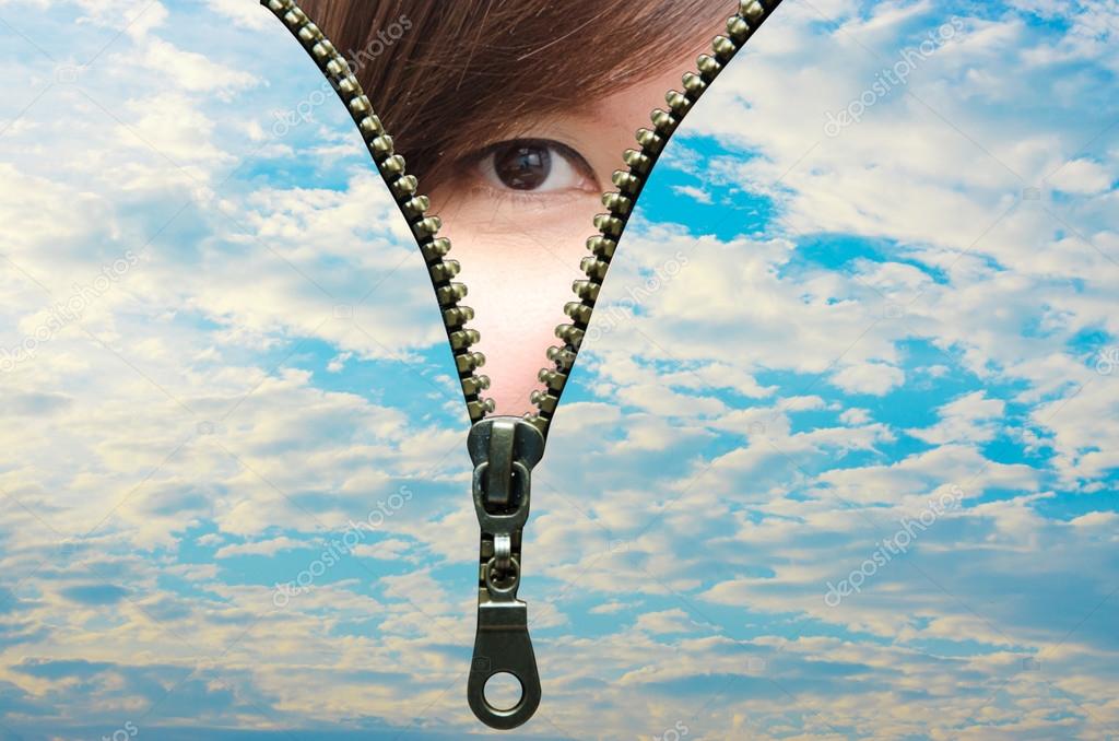 Woman's eyes looking out of zip opened though the sky — Stock Photo ...