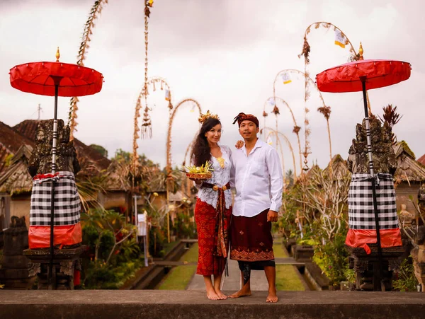 Balinese ceremony. Multicultural couple going to Hindu religious ...