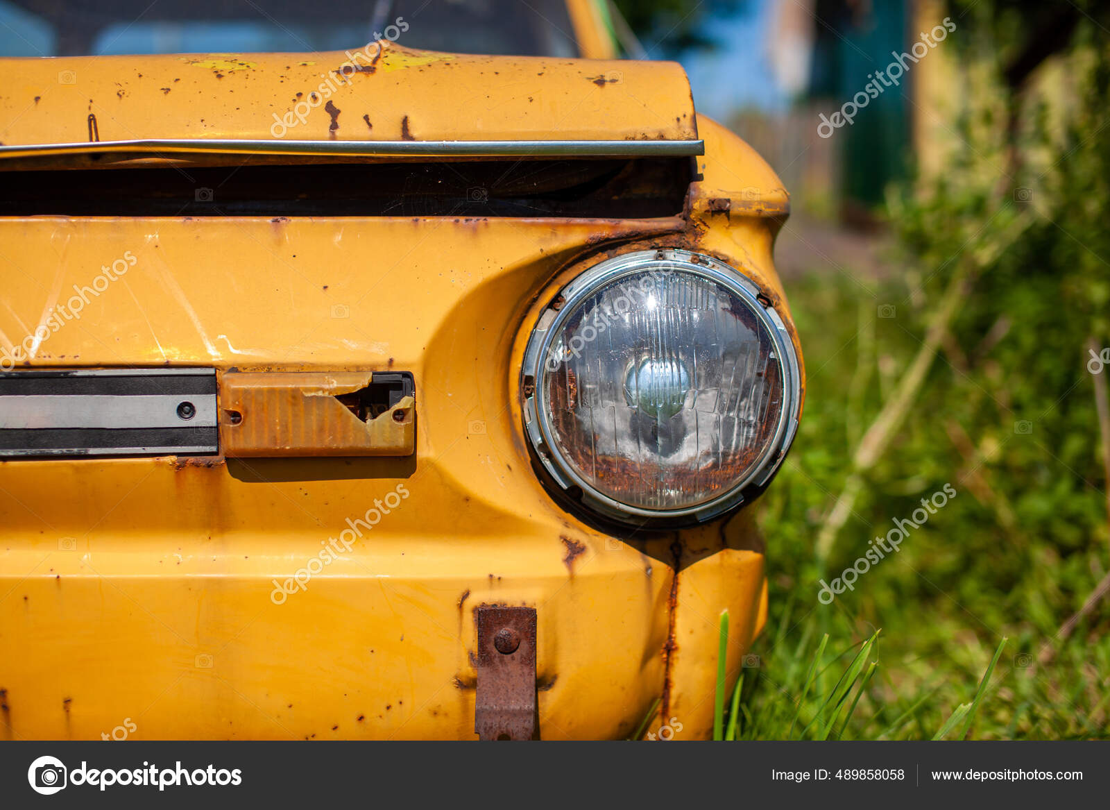 Old yellow wrecked car in vintage style. Abandoned rusty yellow car ...
