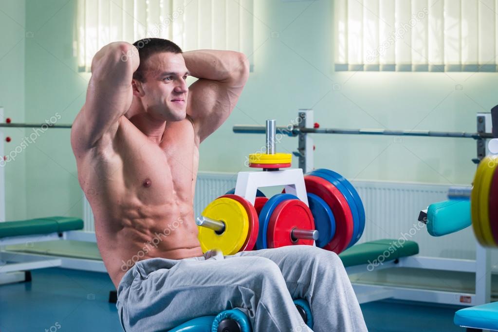 Man trains abdominal muscles — Stock Photo © aallm #61609363