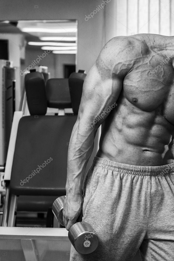 Bodybuilder trains the muscles of the arms. — Stock Photo © aallm #72787113