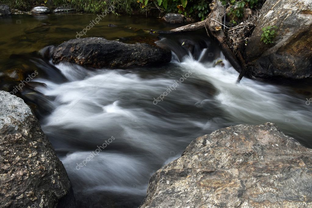 Rock and water stream in nature — Stock Photo © kittimages #98383494