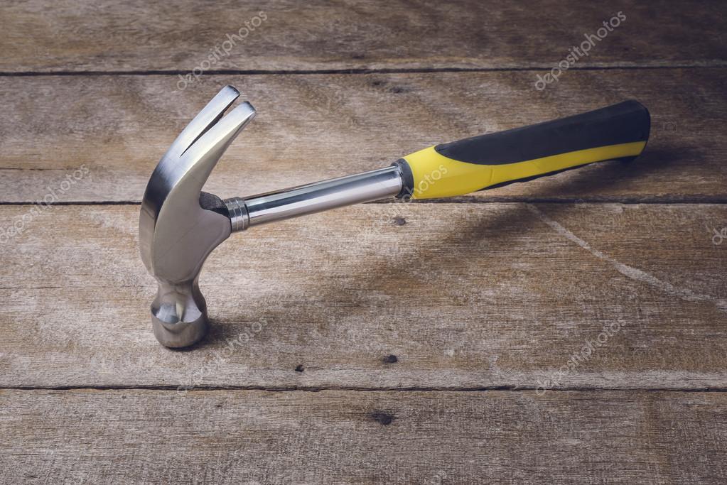 Single handed worn sledge hammer on grunge wood Stock Photo by ...
