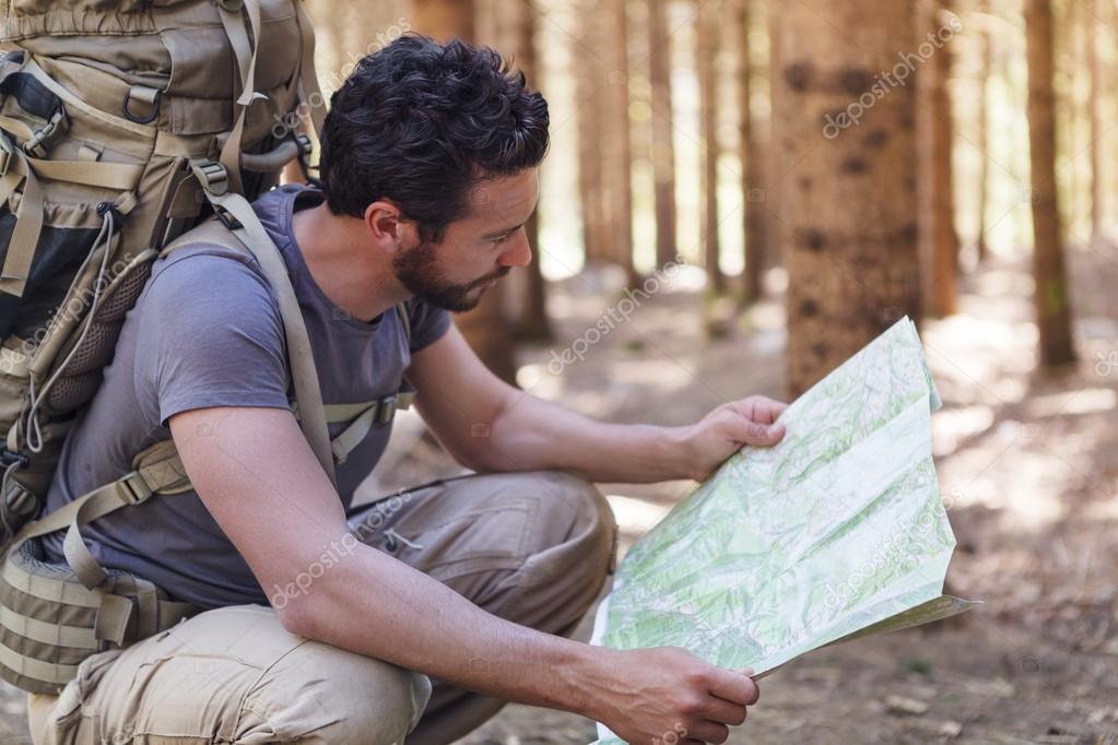 Man with Backpack and map searching directions Stock Photo by ...