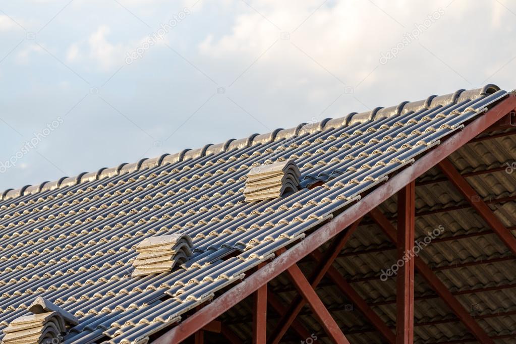 Roof under construction with stacks of roof tiles for home build Stock ...