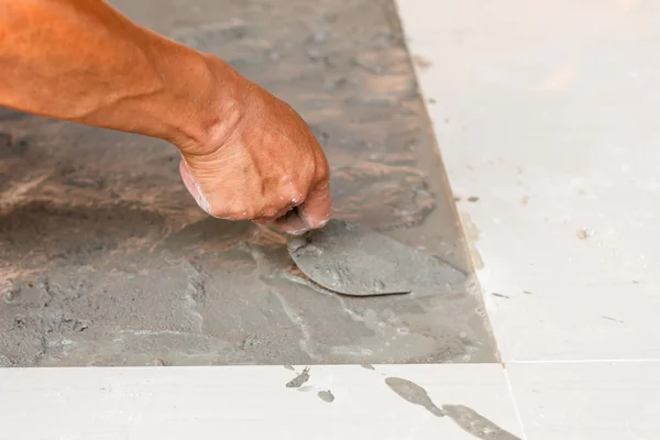 Labor installing tile floor - Stock Image - Everypixel