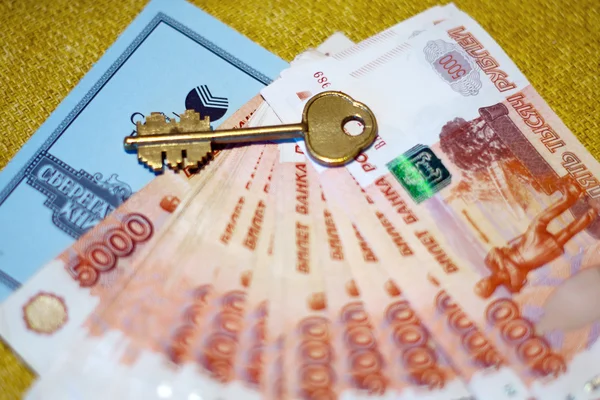 Russian money, savings book and the key - Stock Image - Everypixel