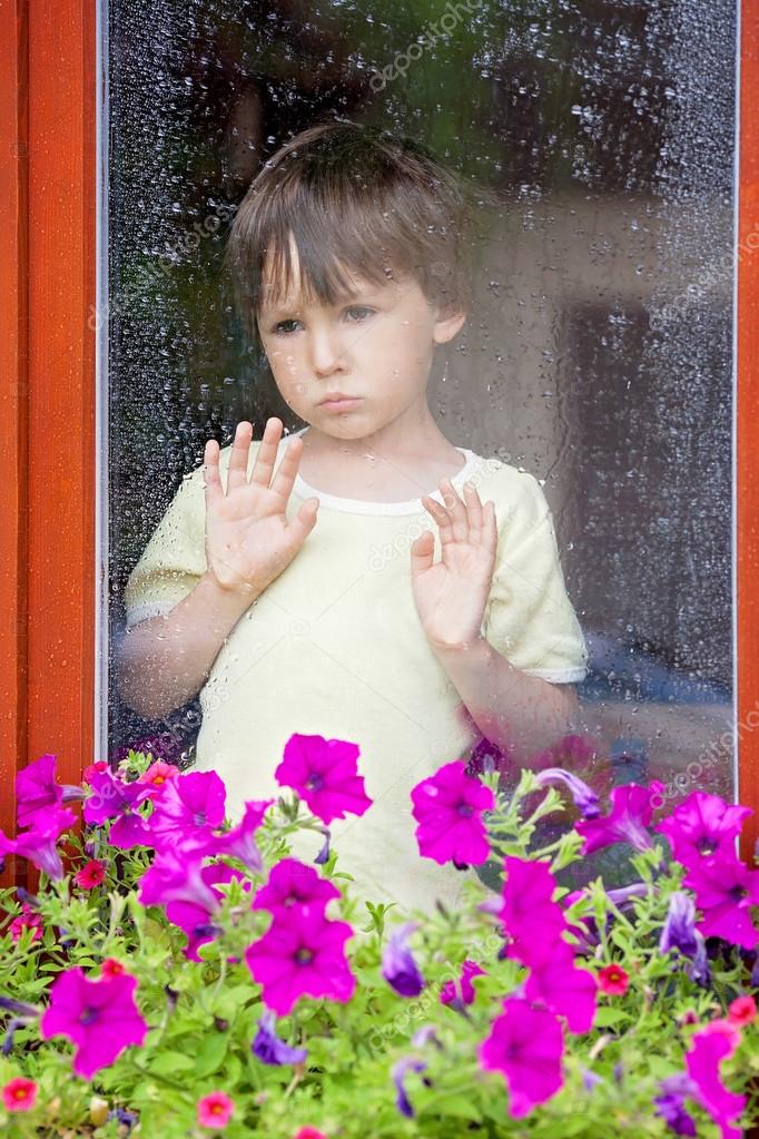 Little boy behind the window in the rain — Stock Photo © t.tomsickova ...