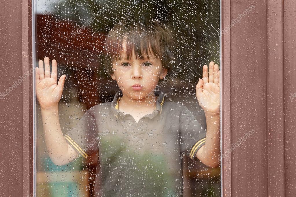 Child Looking Out A Window