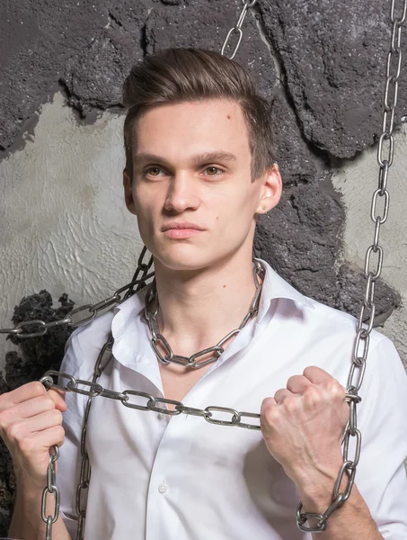A man in a white shirt and tie breaks the chain. - Stock Image - Everypixel
