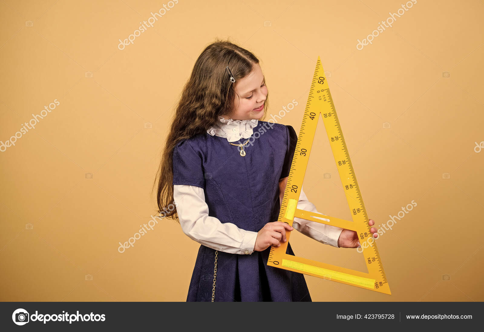 School student learning geometry. Pupil girl with big ruler. math ...