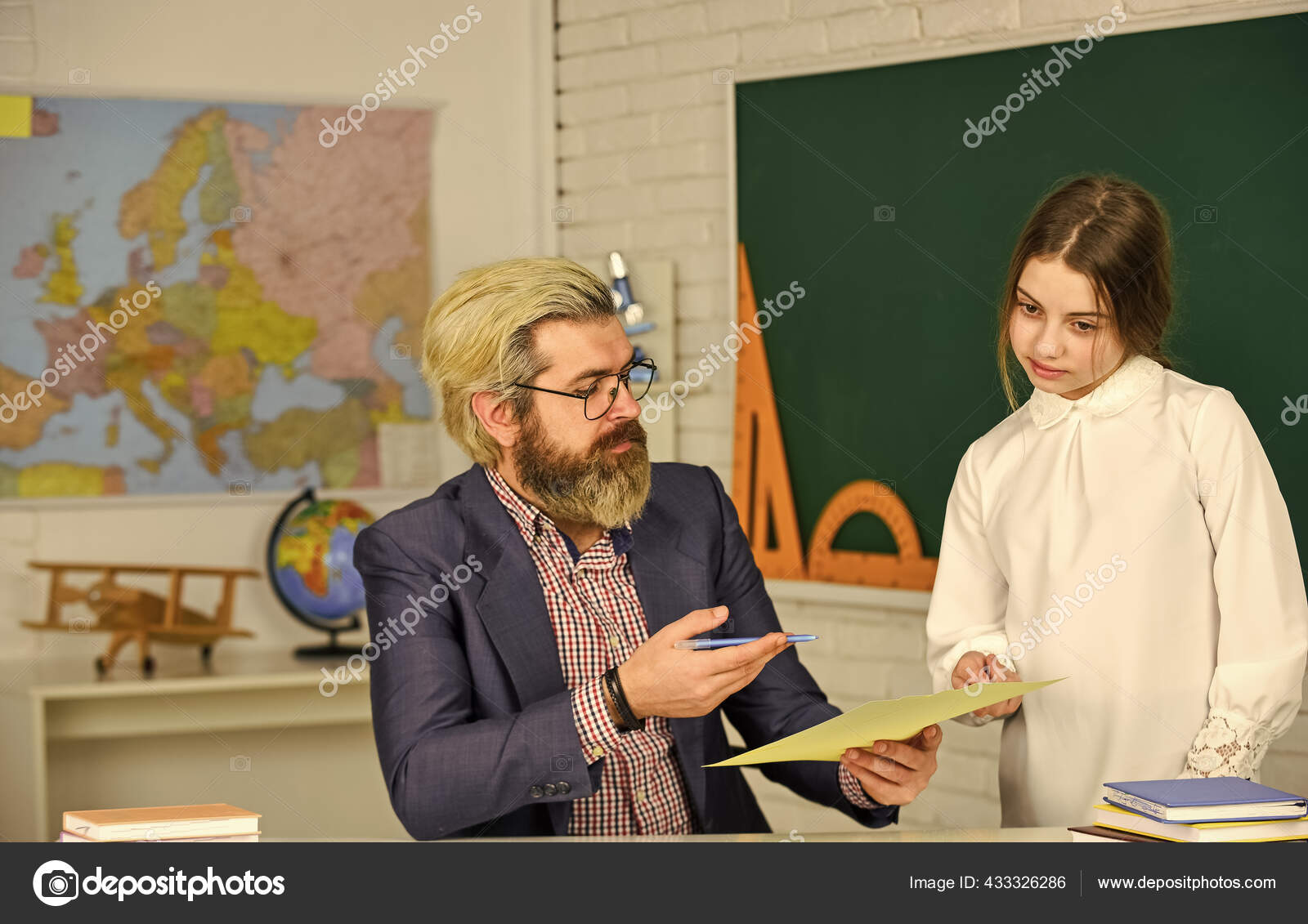 Bearded man teacher in classroom. Teacher checking right answer. Track ...