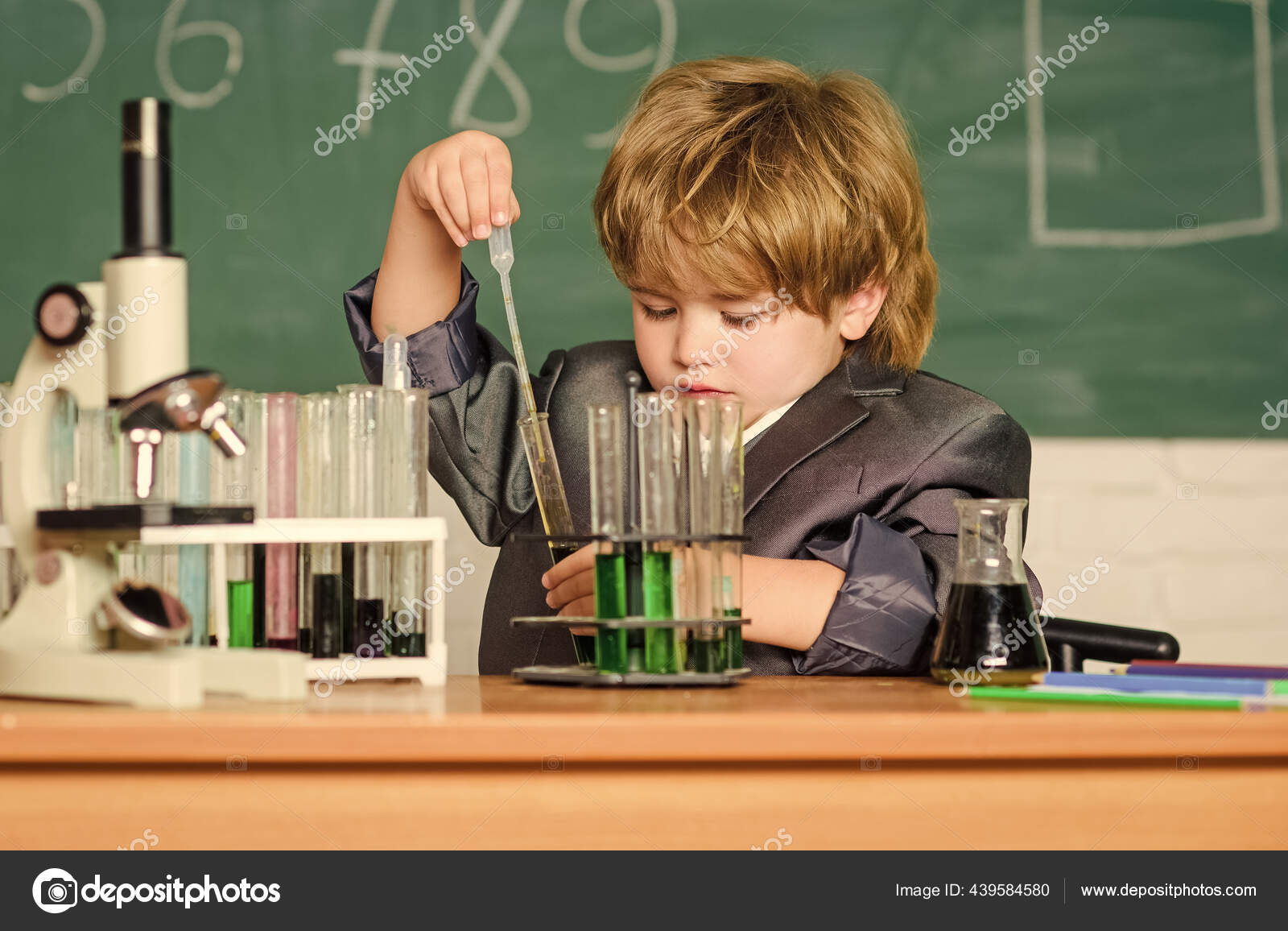 Microscope at lab. small boy using microscope at lesson. student do ...
