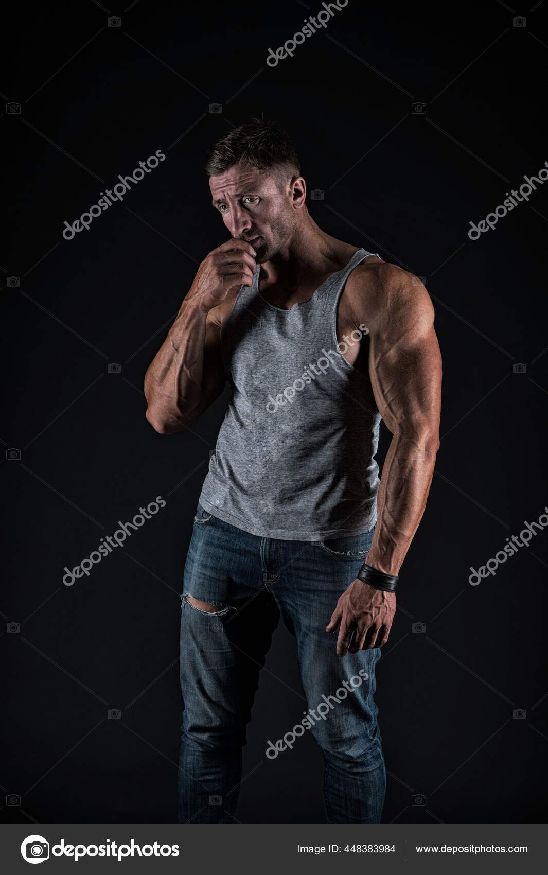 Unhappy bodybuilder wear casual undershirt with jeans showing strong ...