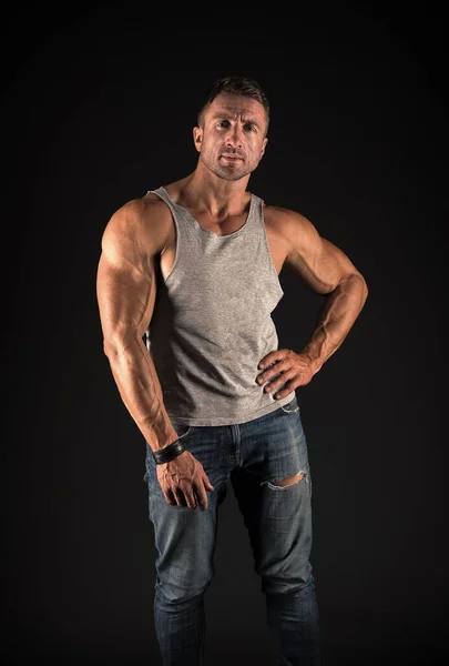 Unhappy bodybuilder wear casual undershirt with jeans showing strong ...
