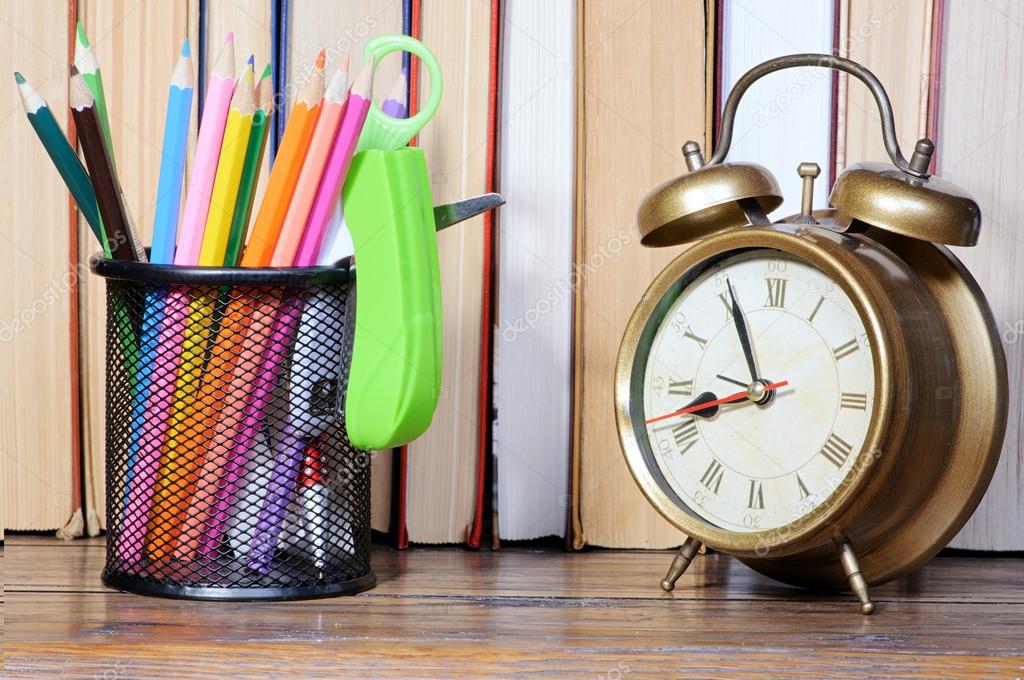 Pencils and clock on shelf Stock Photo by ©olegkrugllyak 70637257