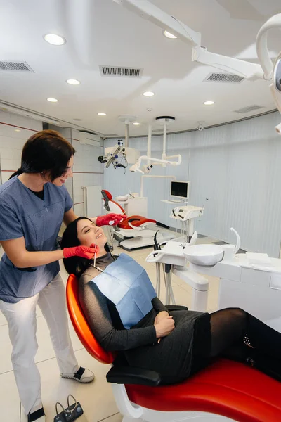 A young doctor treats his patient's teeth. Dentistry - Stock Image ...