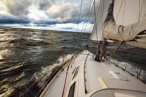 Yacht sailing in an open sea on a winter day. Close-up view from the ...