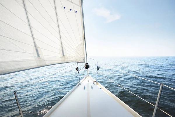 White yacht sailing on a sunny summer day. Top down view from the deck ...
