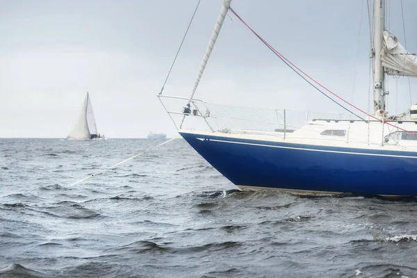 Blue sloop rigged yacht anchored off the coast of England under the ...