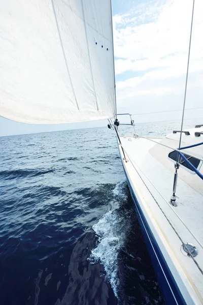White yacht sailing on a sunny summer day. Top down view from the deck ...