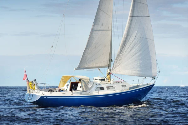 Blue sloop rigged yacht sailing in an open Baltic sea on a clear day ...