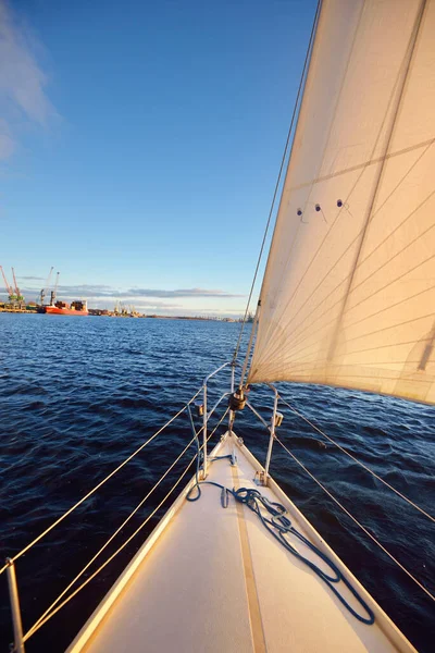 White yacht sailing in Daugava river at sunset. Top down view from the ...