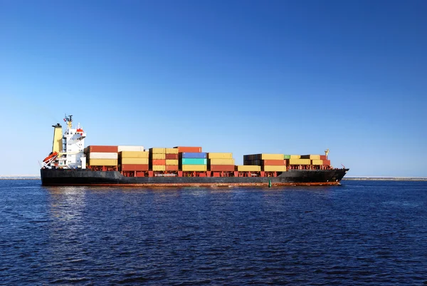 Cargo container ship and small cargo ship sailing in still water ...
