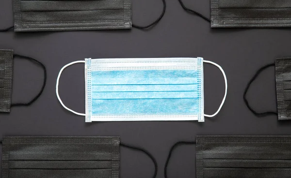 Blue Medical mask, protective face mask on black background with black ...