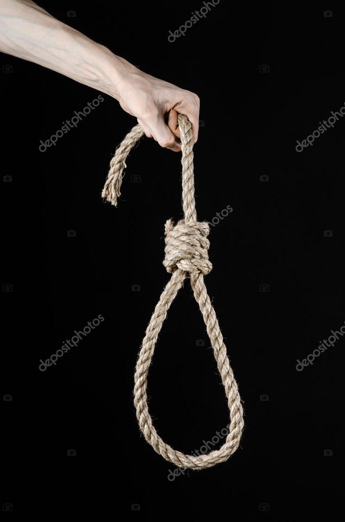 Lynching and suicide theme: man's hand holding a loop of rope for ...