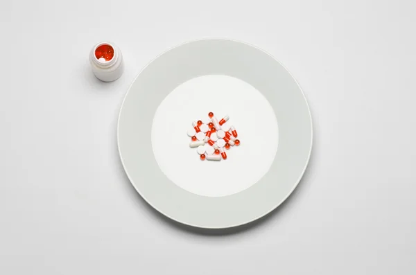 Medications and improper nutrition topic: human hand hold a plate with ...