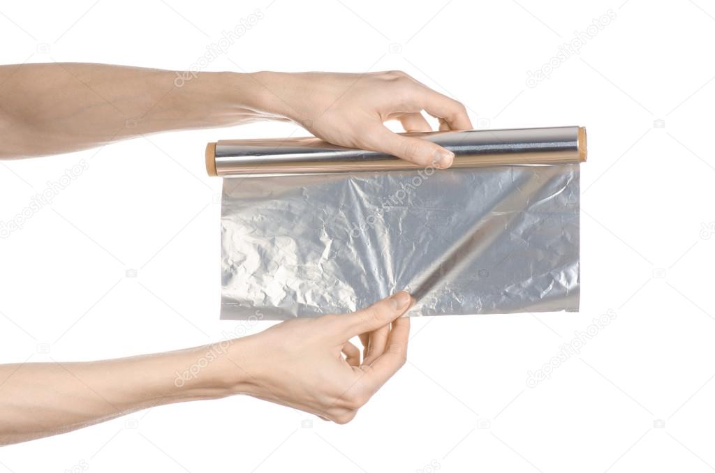 Cooking and shisha topic: human hand holding a foil isolated on white ...