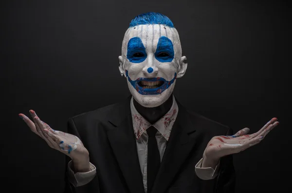 Terrible clown and Halloween theme: Crazy blue clown in a black suit ...